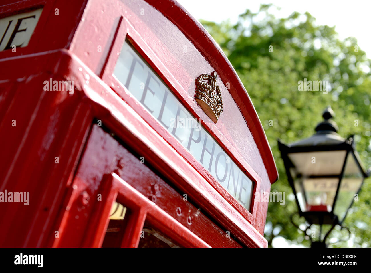 red telephone box with old fashioned london street light in soft focus ...