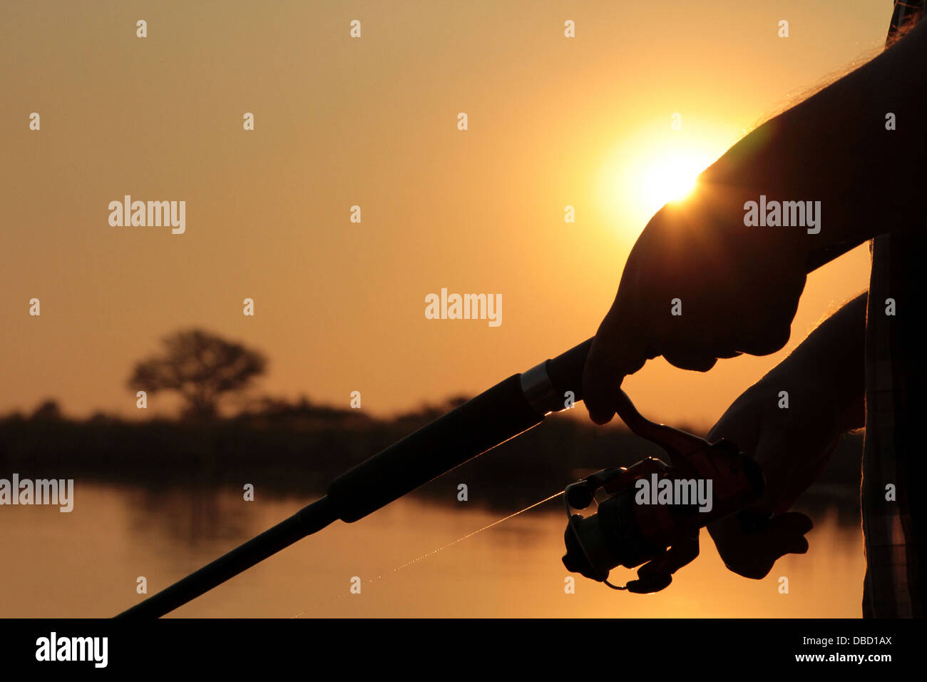 Fishing through the sunset on the Kavango on the Caprivi strip Stock ...