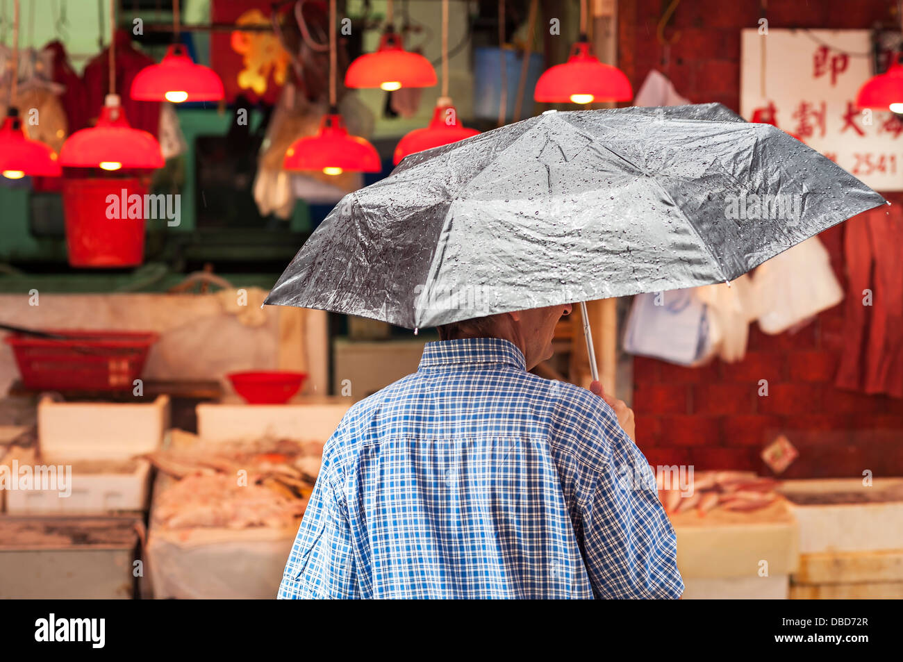 Man holding umbrella hi-res stock photography and images - Alamy