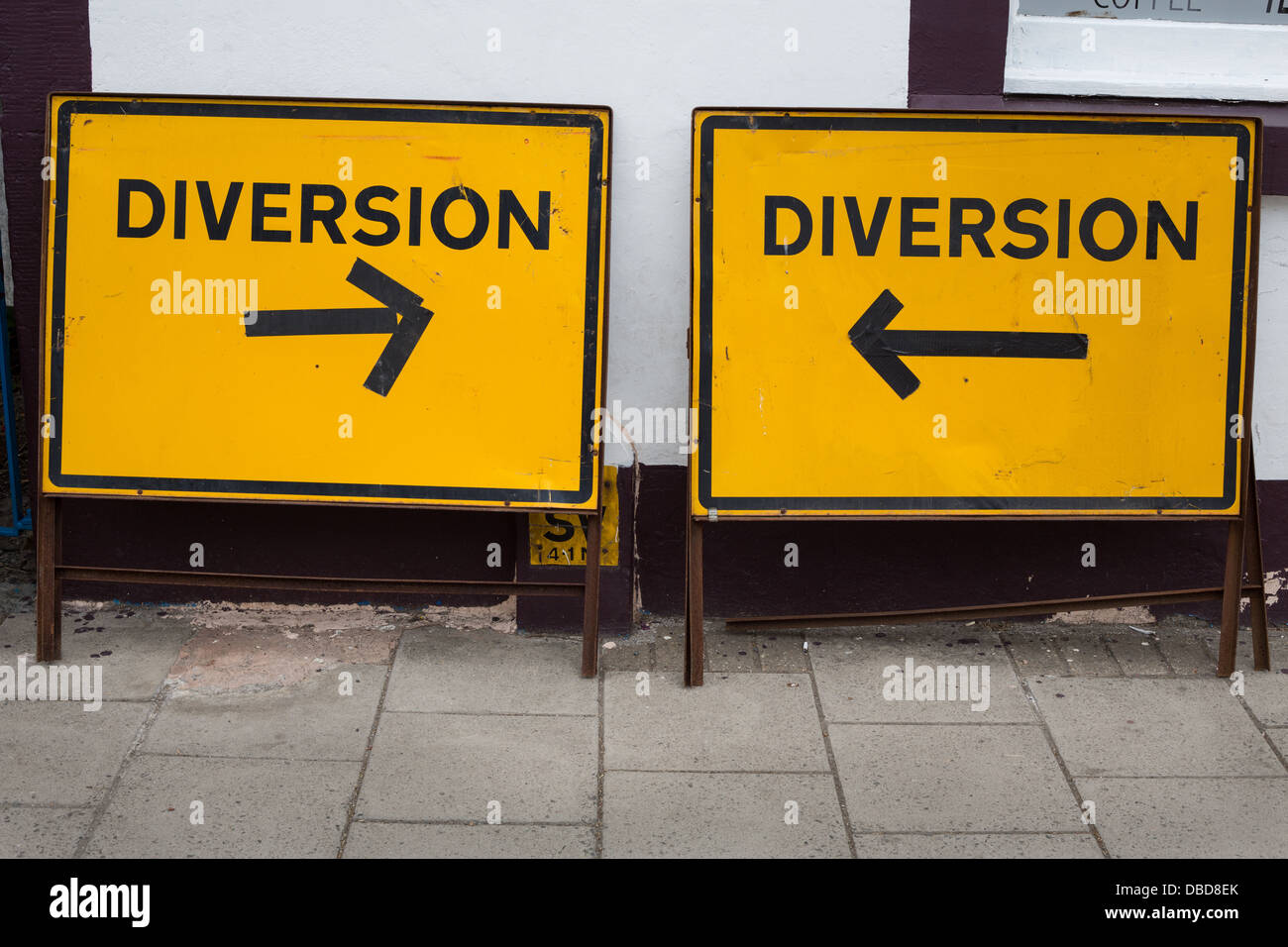 Diversion road signs pointing at each other Stock Photo - Alamy