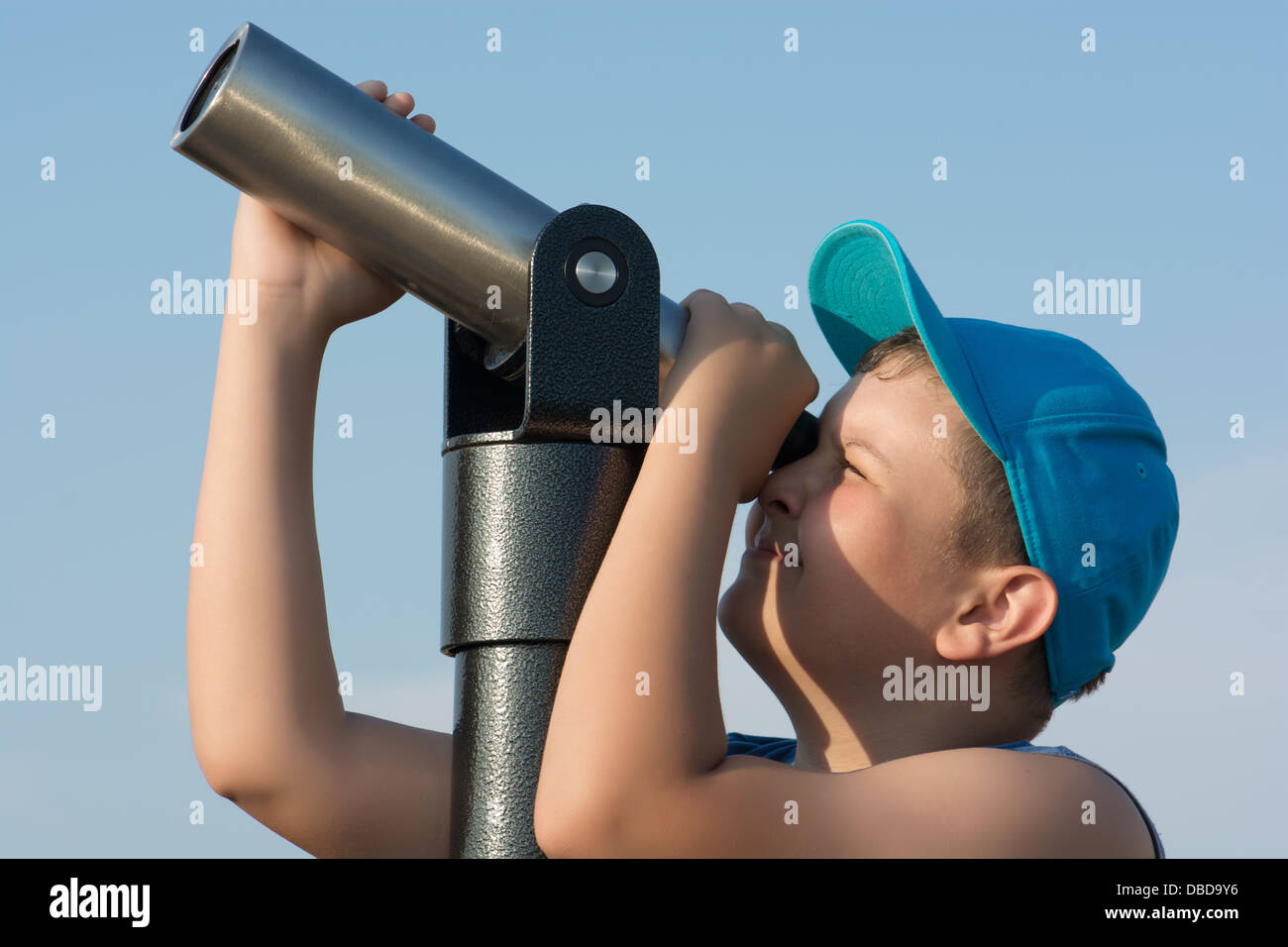 Young caucasian boy looking through a telescope Stock Photo - Alamy