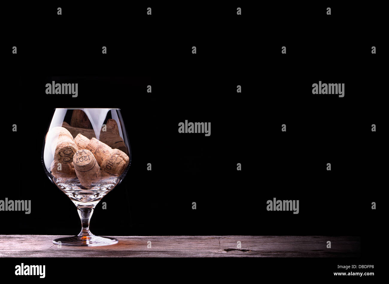 corks in glass isolated on black background Stock Photo - Alamy