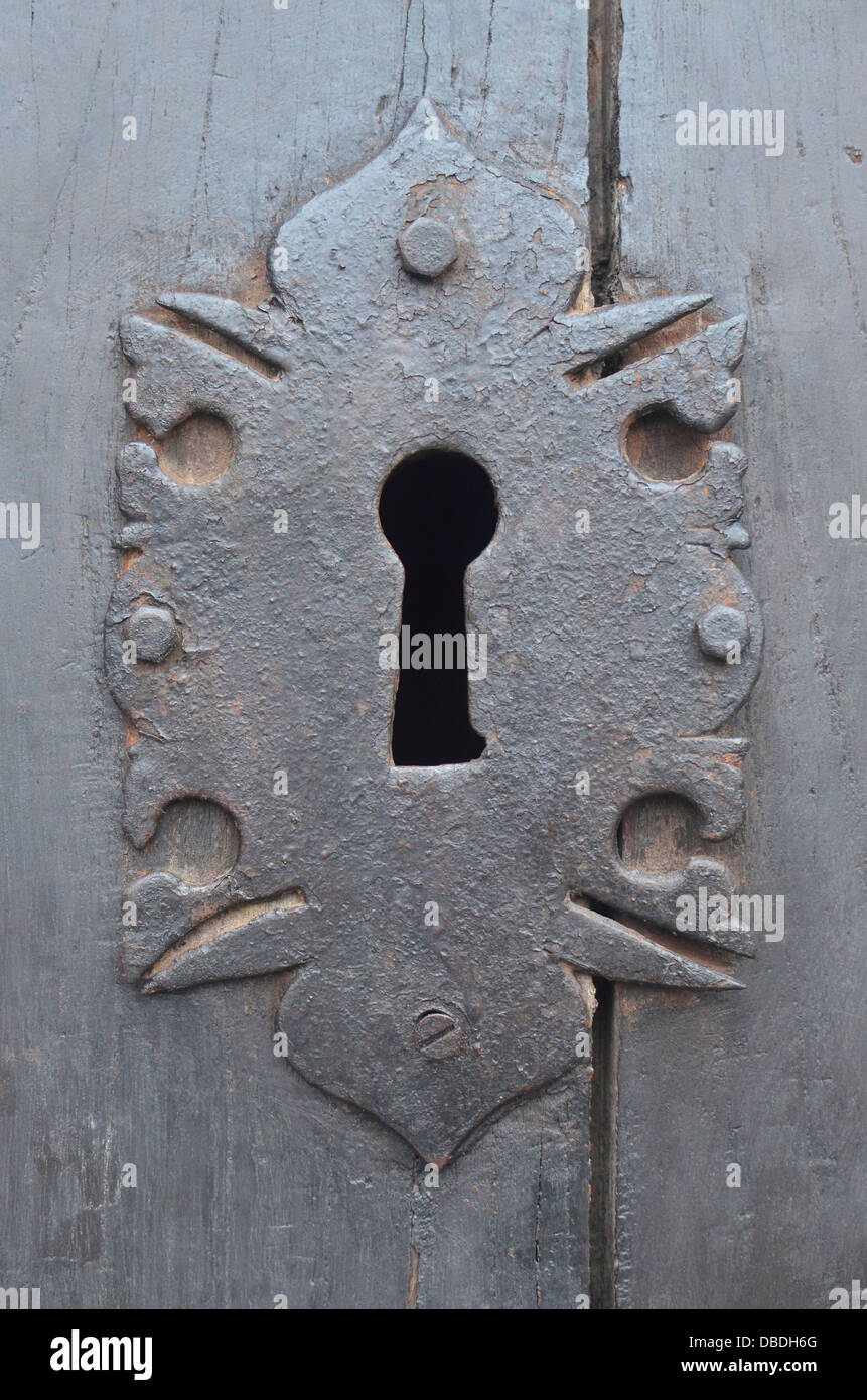 An old metal keyhole on a wooden door Stock Photo - Alamy