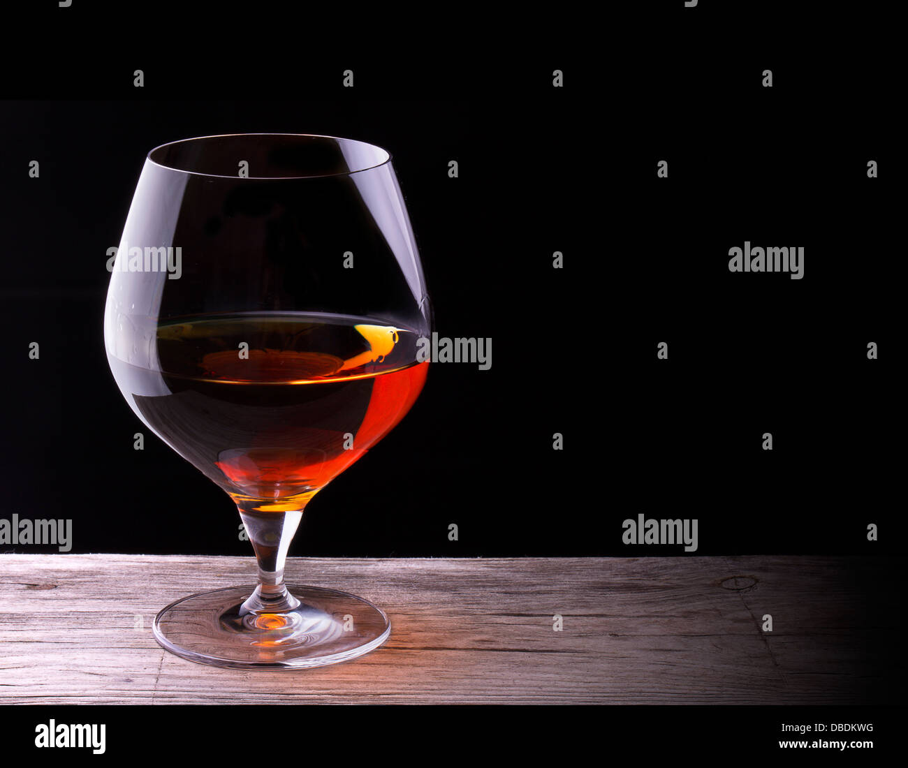 Cognac or brandy on a wooden vintage table with black background Stock ...