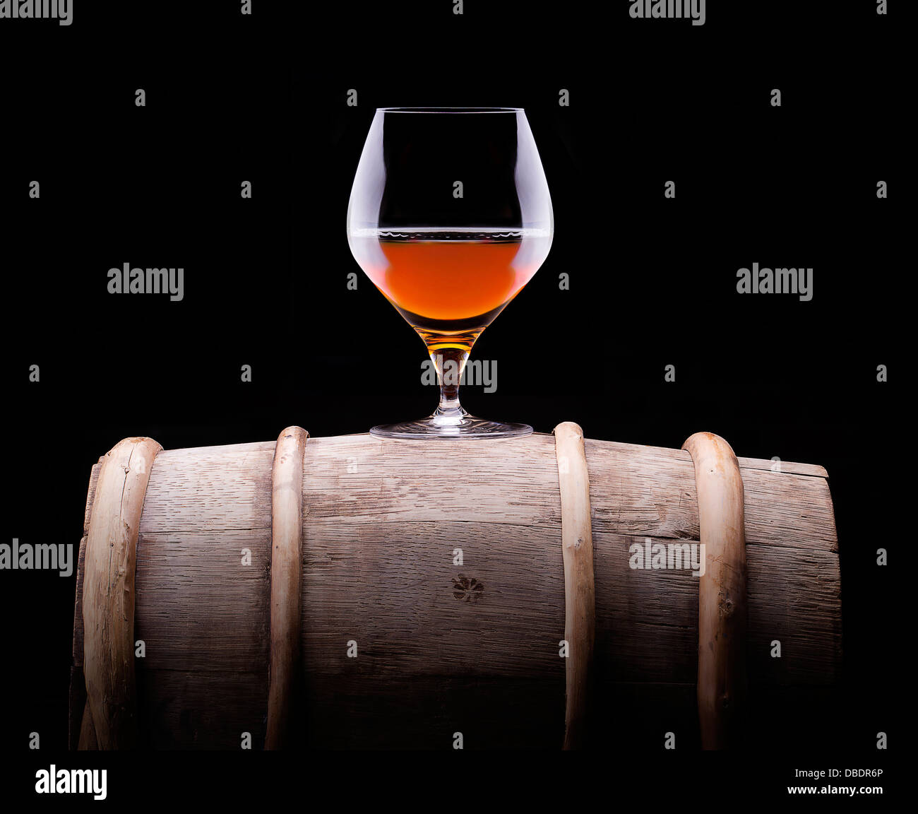 Cognac or brandy on a wooden vintage barrel with black background Stock ...