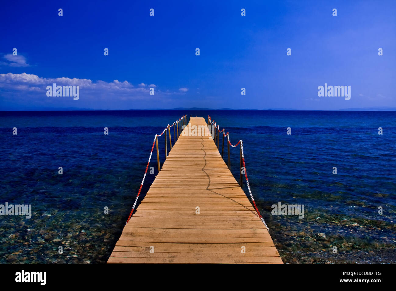 wooden peer on blue sea with blue sky Stock Photo - Alamy
