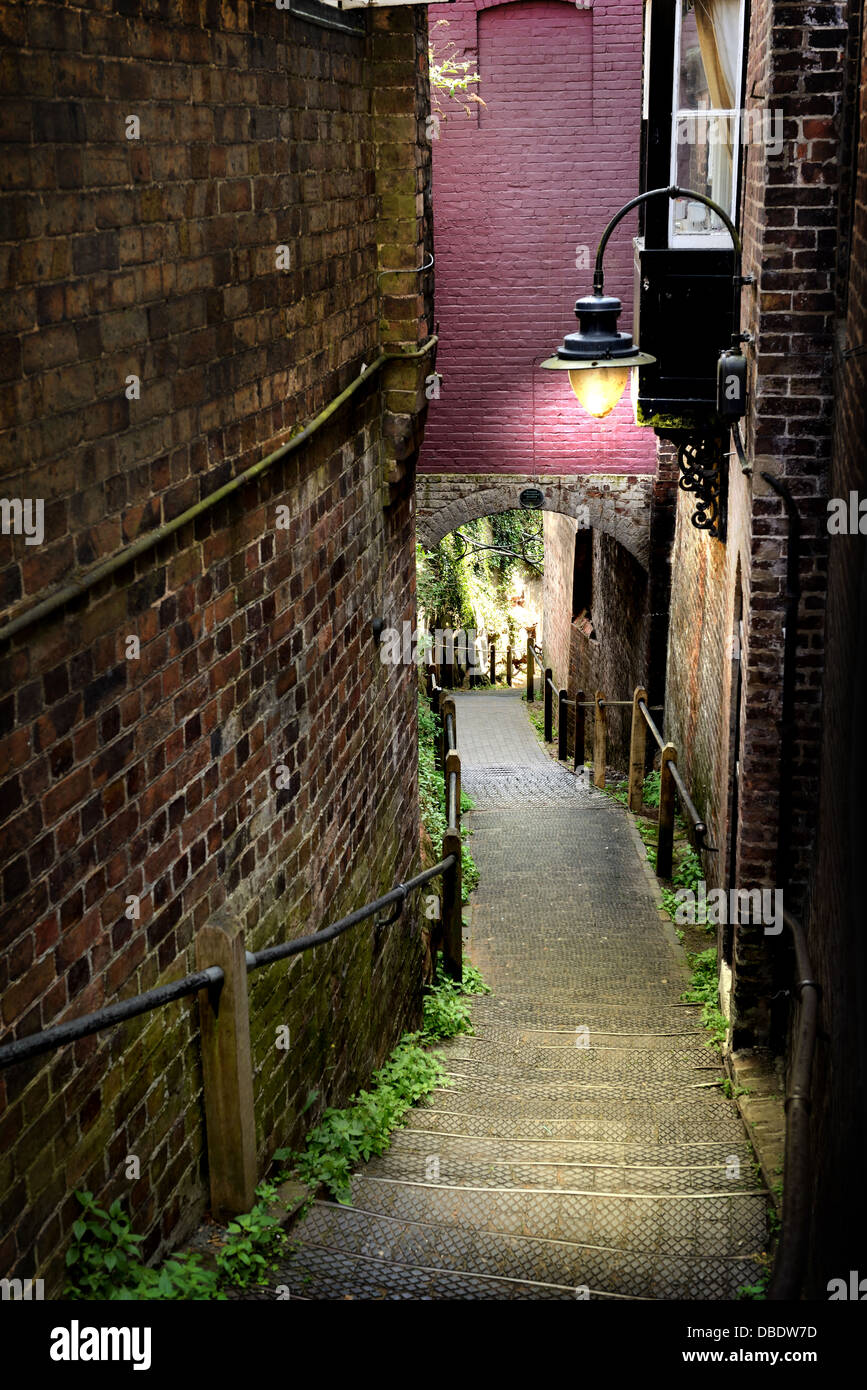 narrow walkway steps leading downhill with an Old-fashioned light, dust ...