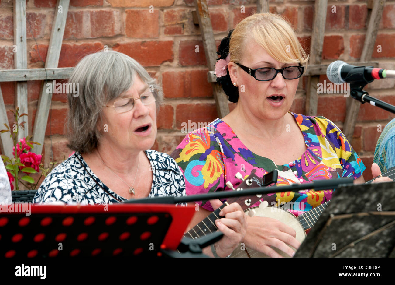 Women in a ukulele group singing Stock Photo - Alamy
