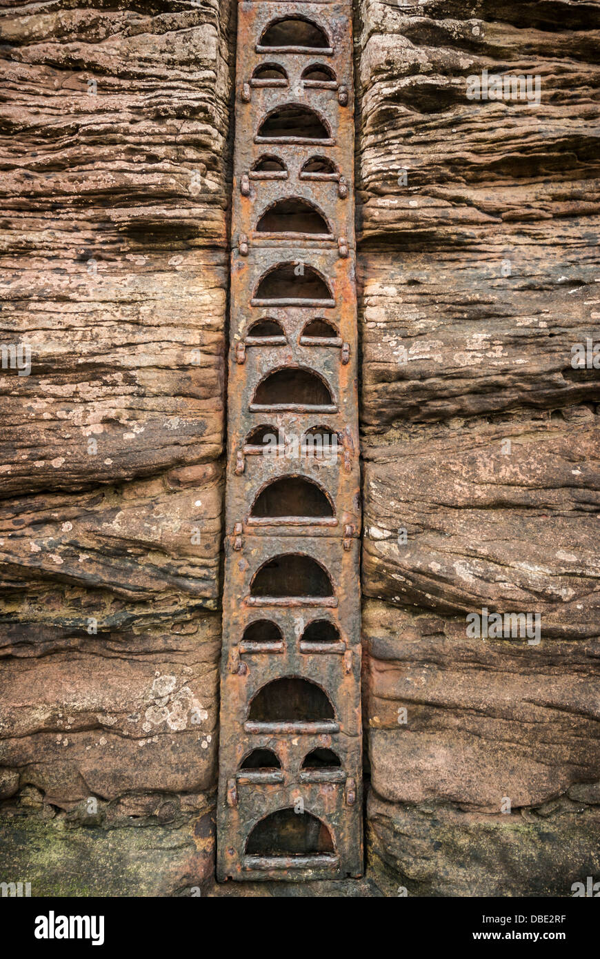 An unusual old cast iron ladder set into sandstone Stock Photo - Alamy