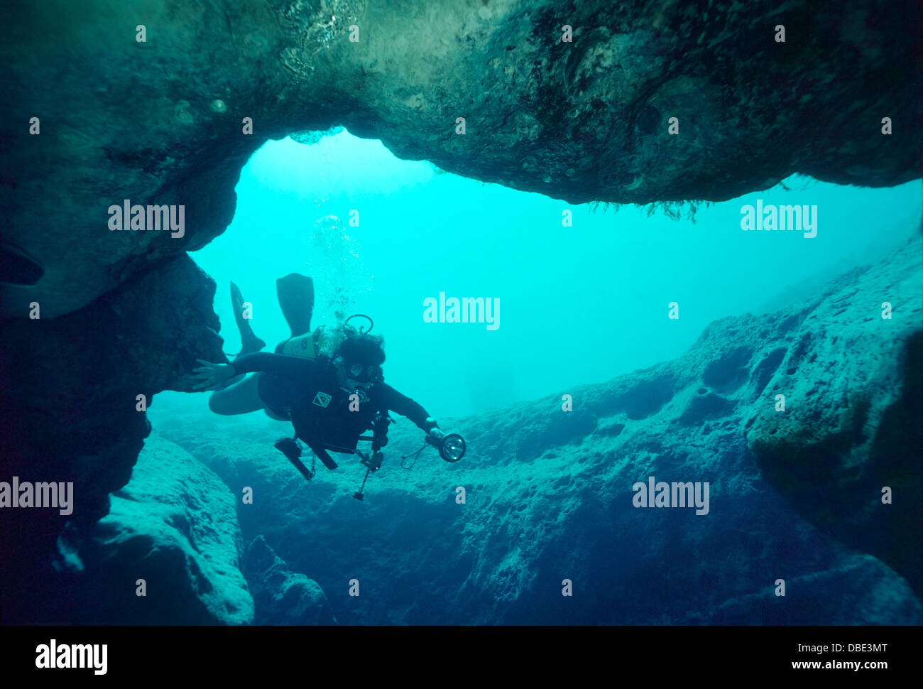 Scuba diver approaches the entrance to an underwater cave in North ...