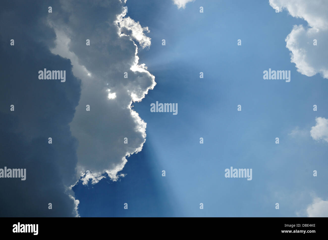 Sunlight streaming through cumulus clouds Stock Photo - Alamy