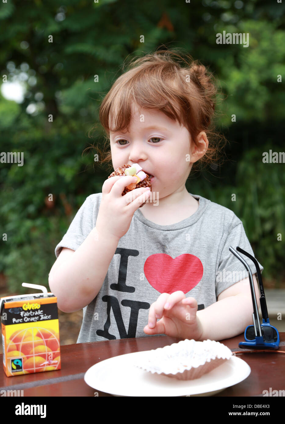 Toddler eating cake Stock Photo - Alamy