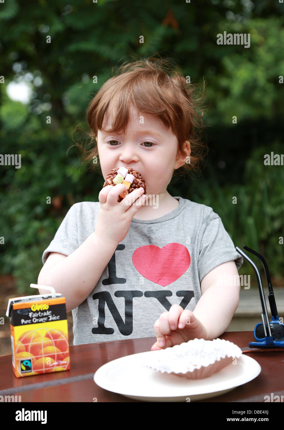 Kid eating chocolate cake hi-res stock photography and images - Alamy