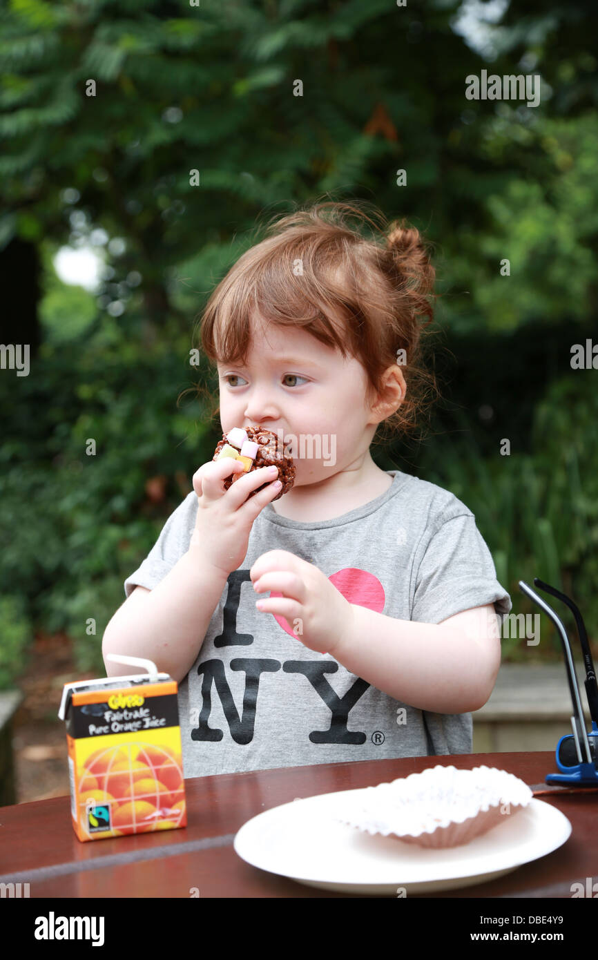 Toddler eating cake Stock Photo - Alamy