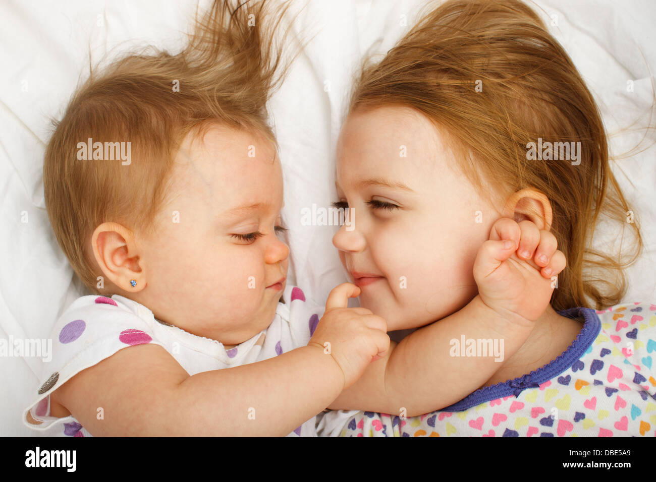 Siblings cuddling in bed Stock Photo - Alamy