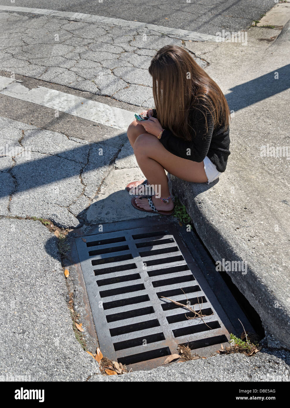 Sitting on curb hi-res stock photography and images - Alamy