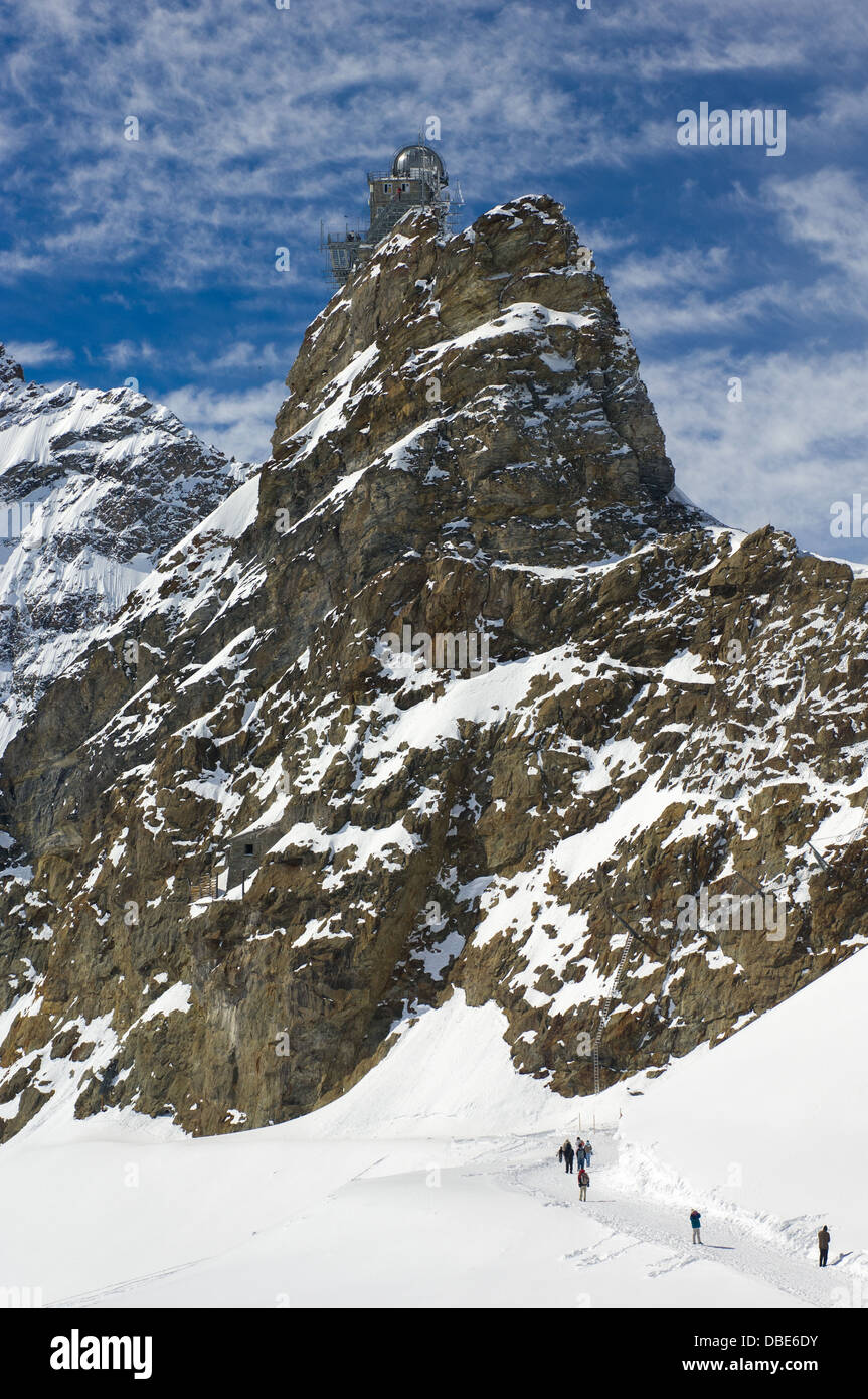Tourists walking across the Mönchsjoch Hut trail at the top of the ...