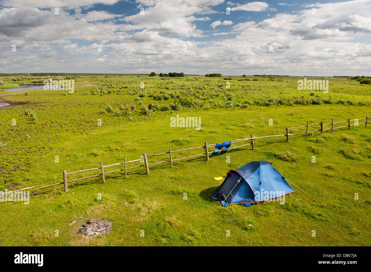 Camping tent and grass expanse landscape Stock Photo - Alamy