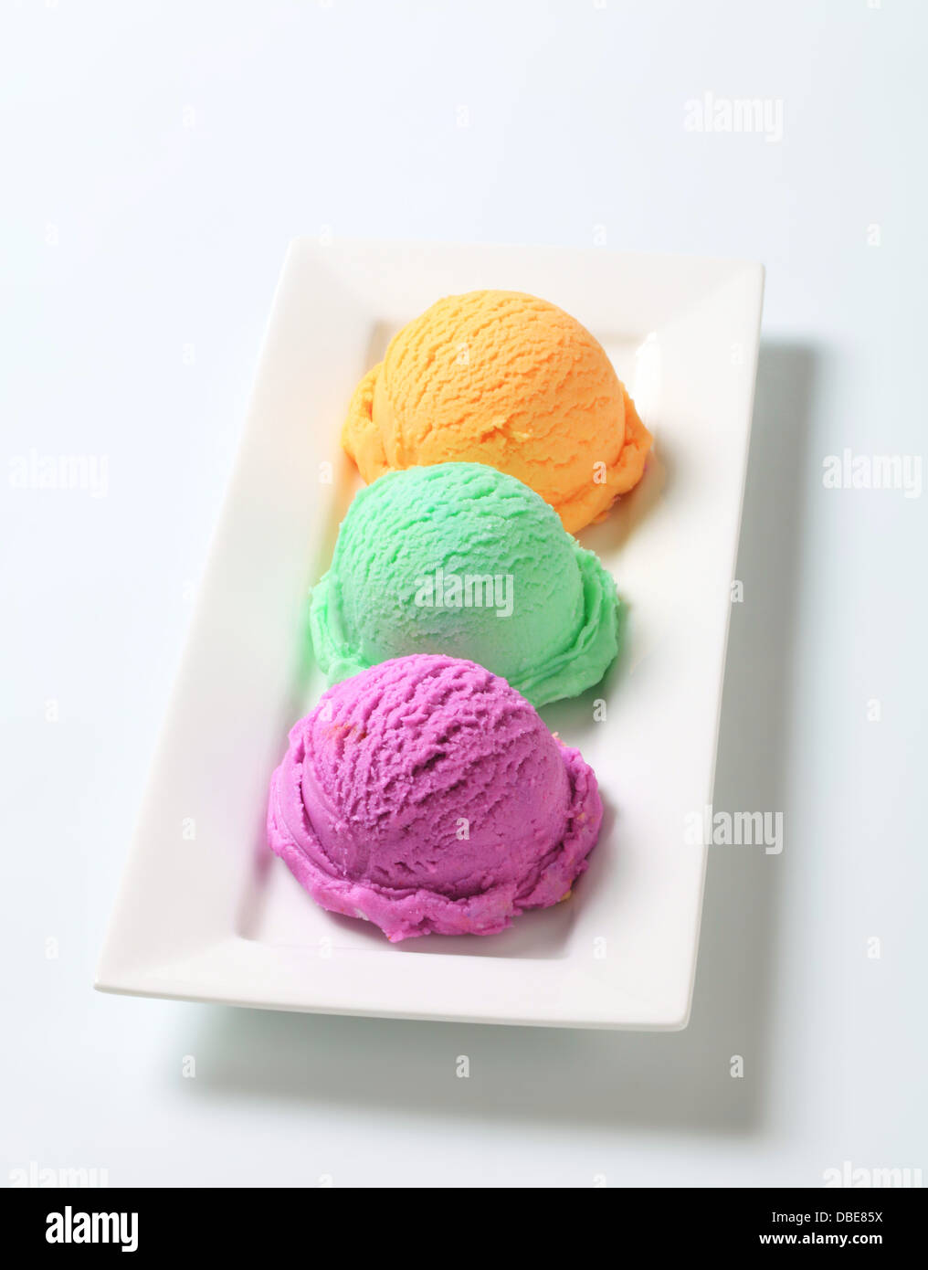 Three scoops of ice cream on long plate Stock Photo - Alamy