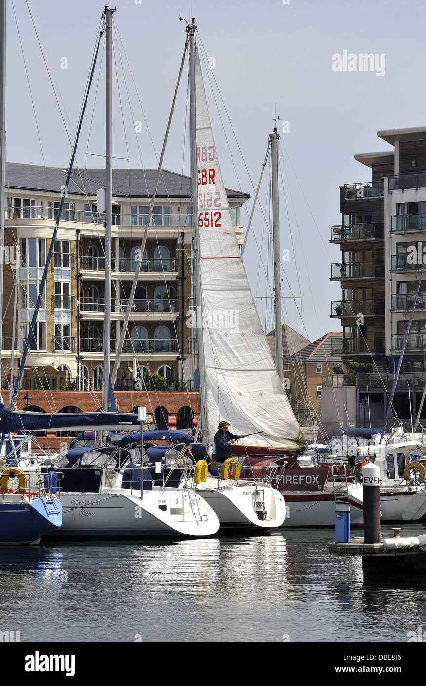 Man washing sail of berthed boat with pressure lance Stock Photo - Alamy