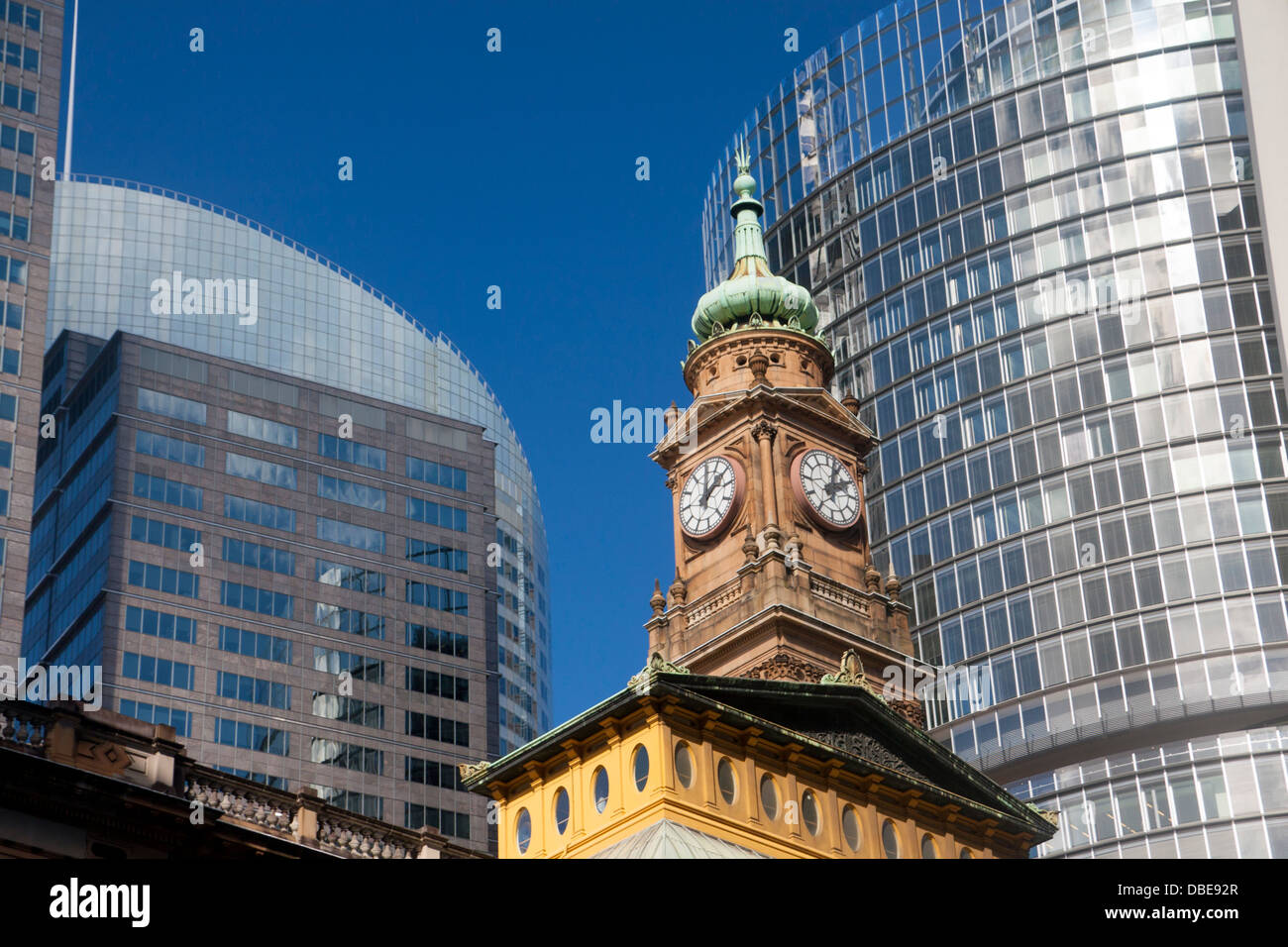 Clock tower of Lands Department building with glass fronted skyscraper ...