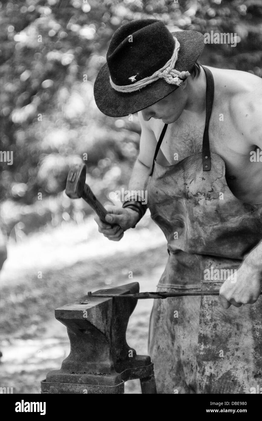 Artistic blacksmith making horseshoe on anvil Stock Photo - Alamy