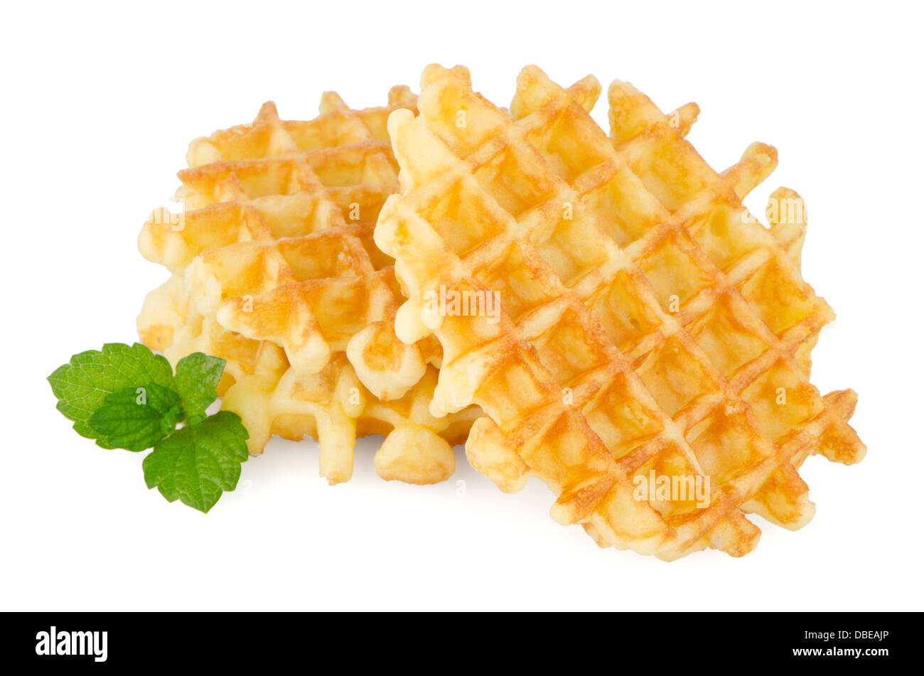 Pile of sweet waffles with green mint leaves isolated on white ...