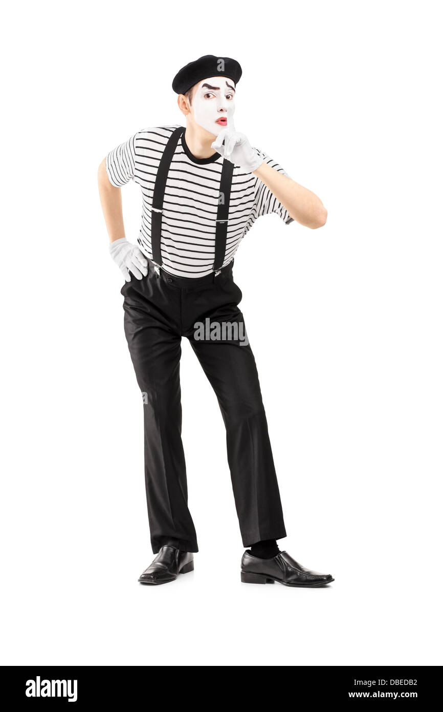 Full length portrait of a male mime artist gesturing silence with a ...