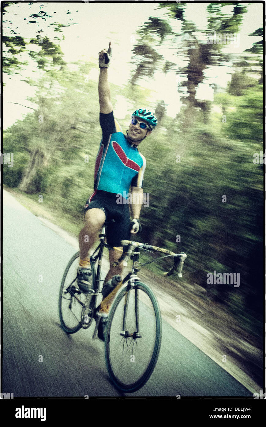Blurred view of cyclist cheering Stock Photo - Alamy