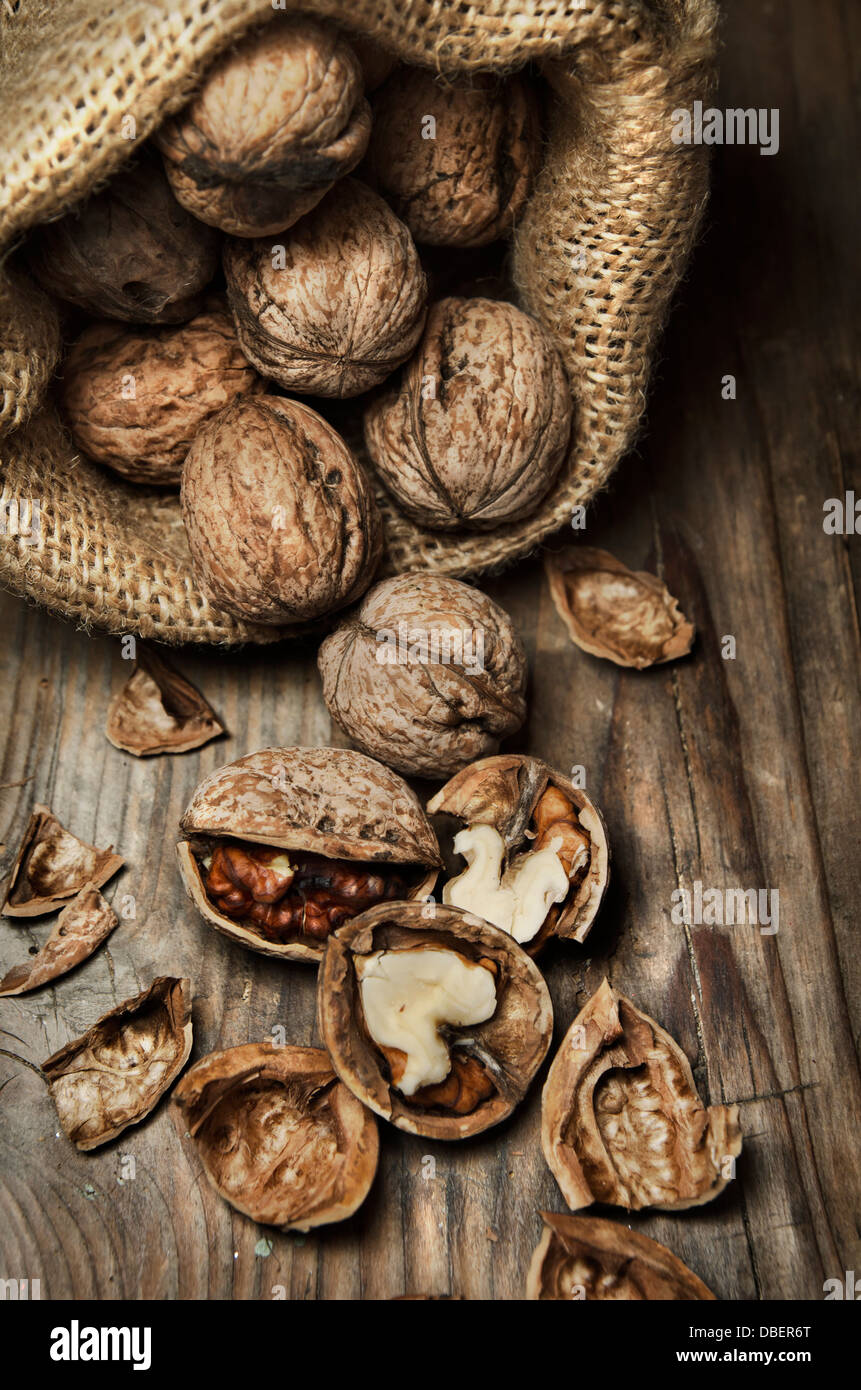 Cracked walnuts on rustic wooden table Stock Photo - Alamy