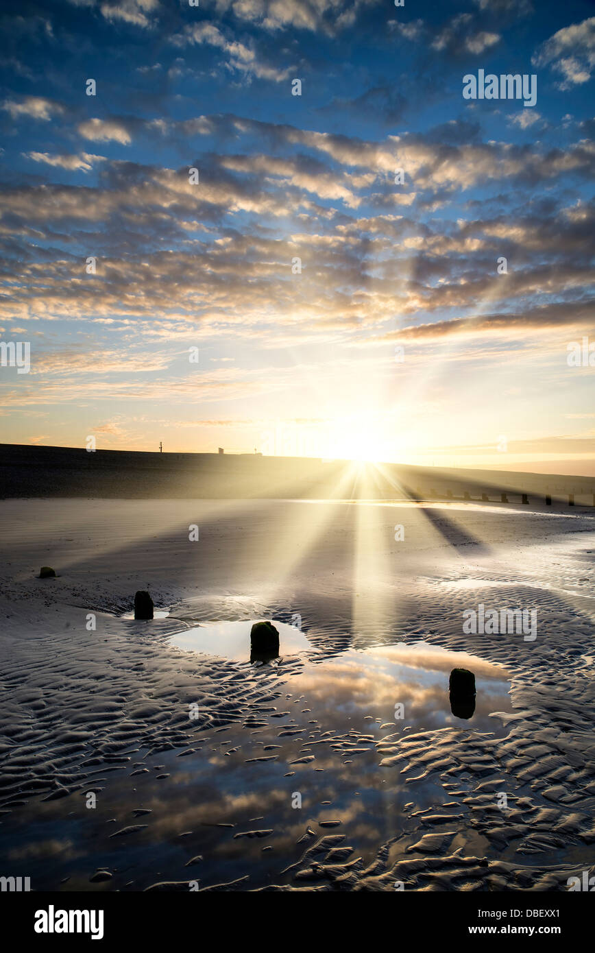 Reflections of sky in pools of water on beach hi-res stock photography ...