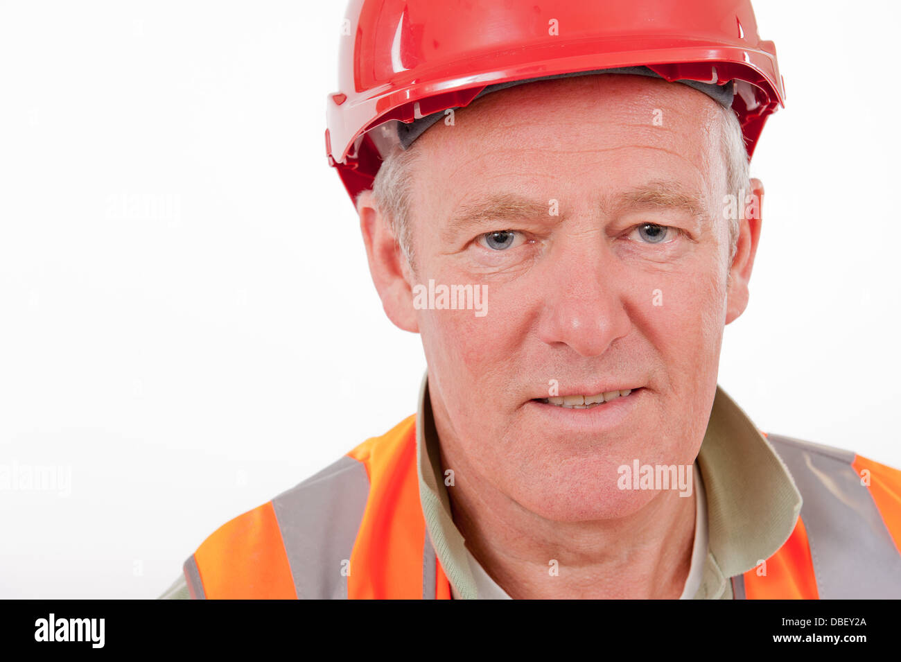 Portrait of a construction worker wearing red safety helmet, against a ...