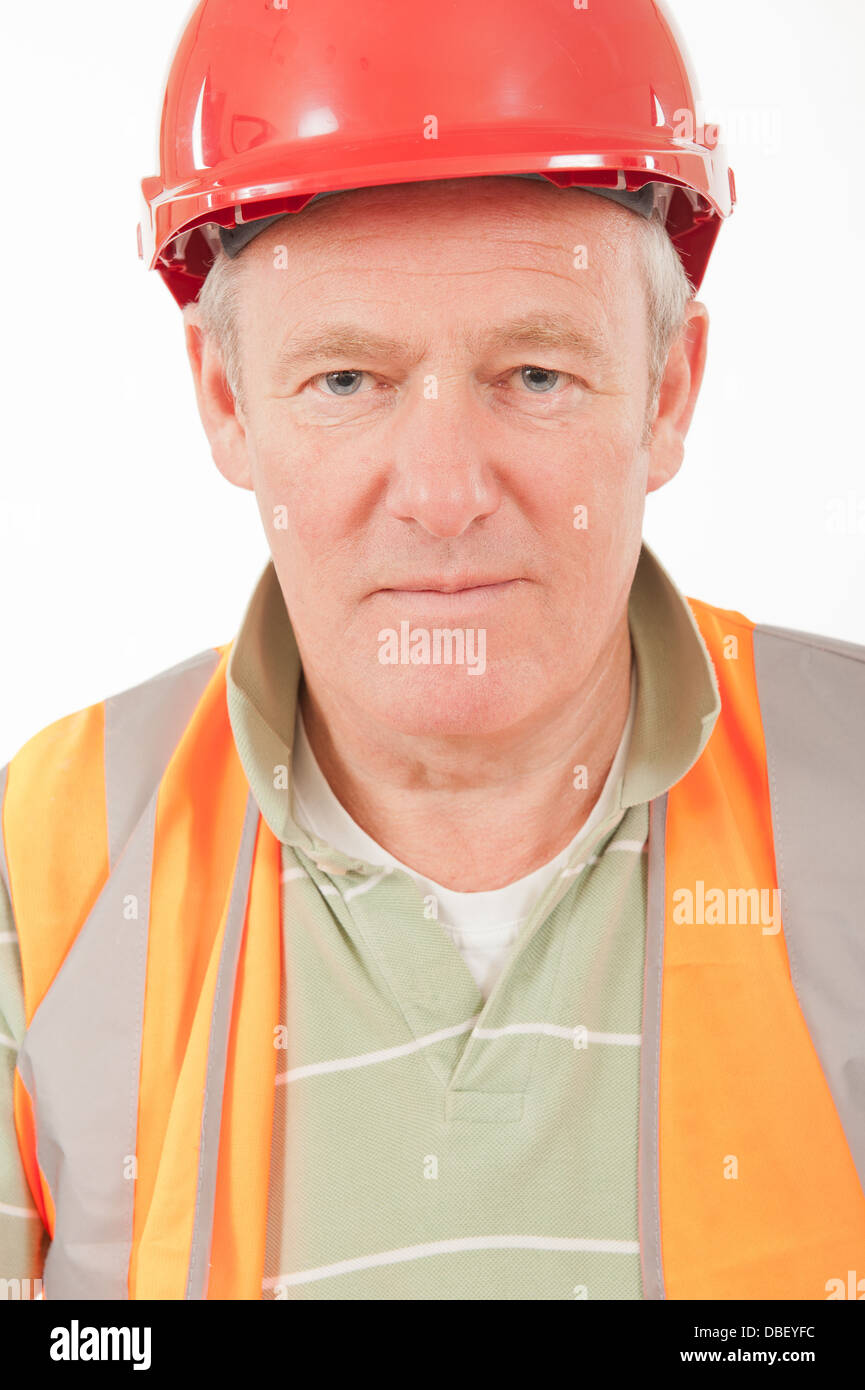 Portrait of a construction worker wearing red safety helmet, against a ...