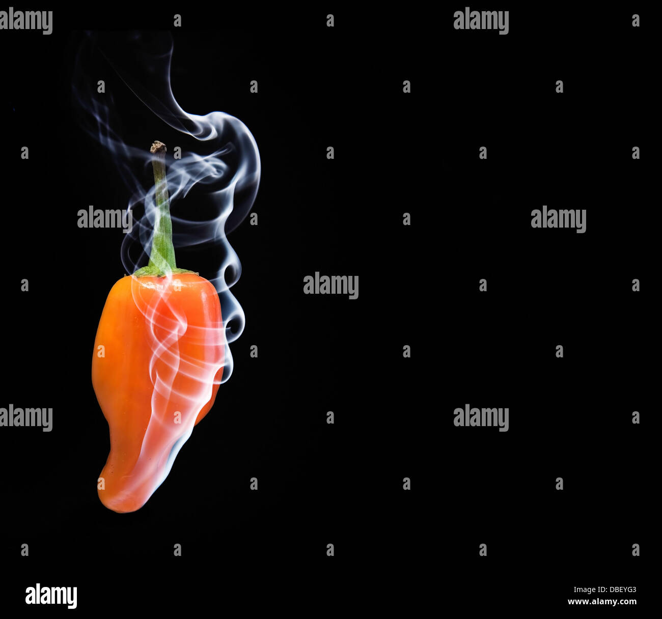 Hot orange chilli pepper with smoke coming out of tip hot concept Stock ...