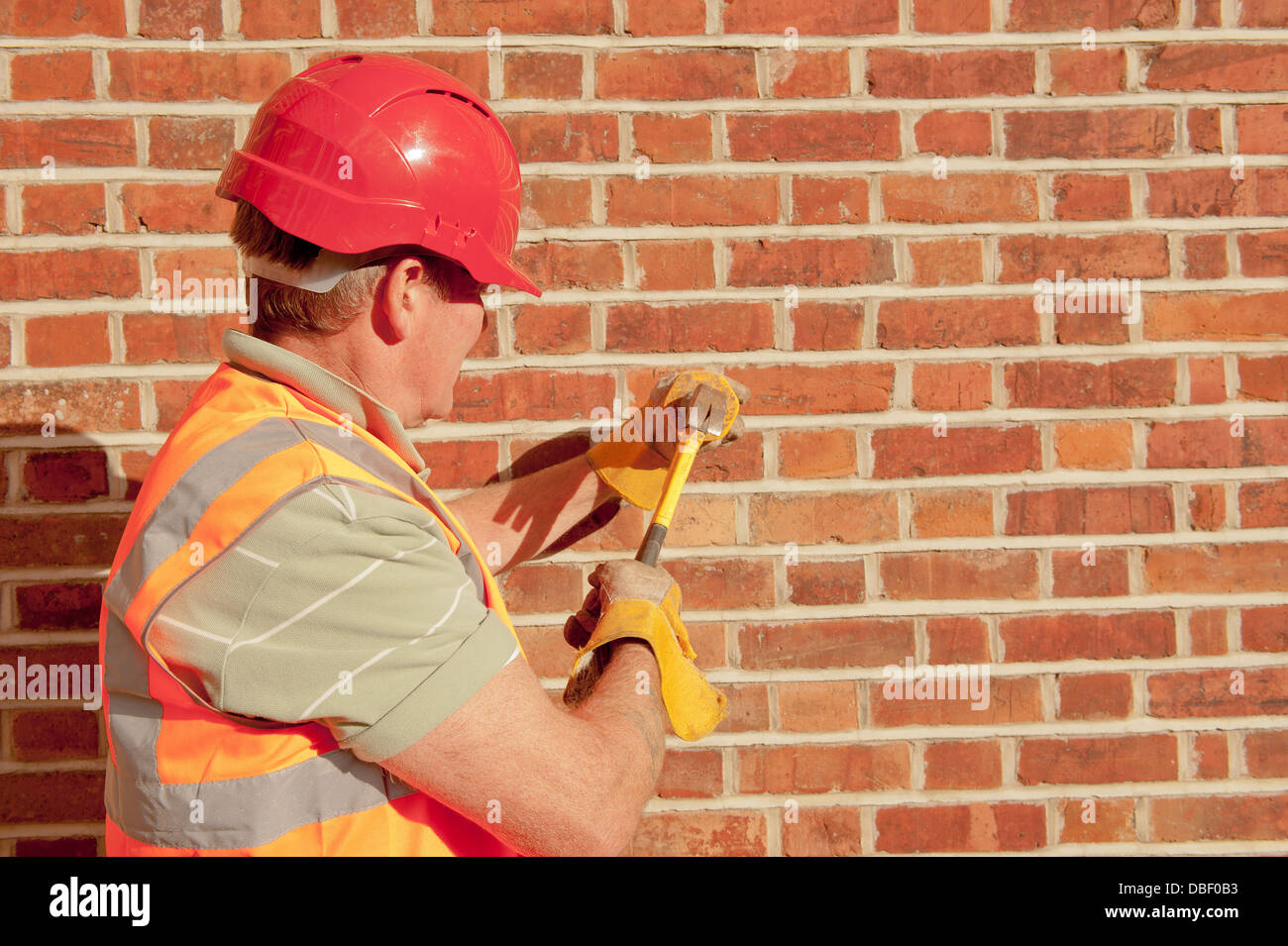 Construction worker about to start repair work on a brick wall Stock ...