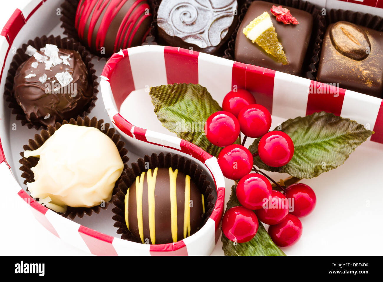 Assorted truffles in candy cane box on a white background Stock Photo ...