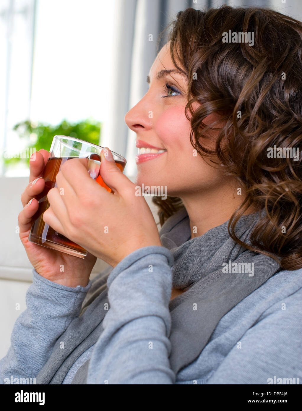 Beautiful Young Woman drinking hot tea Stock Photo - Alamy