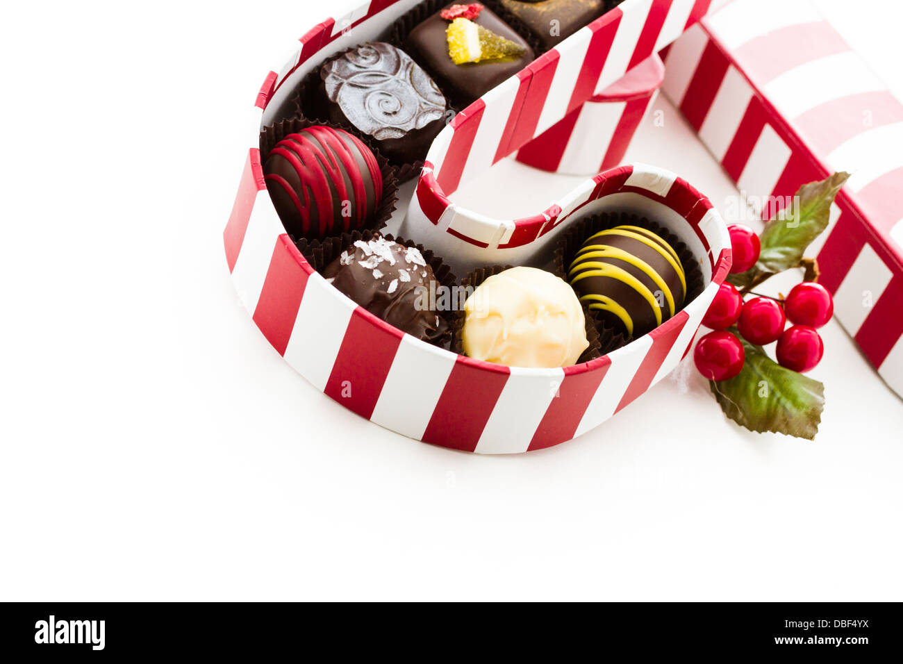 Assorted truffles in candy cane box on a white background Stock Photo ...
