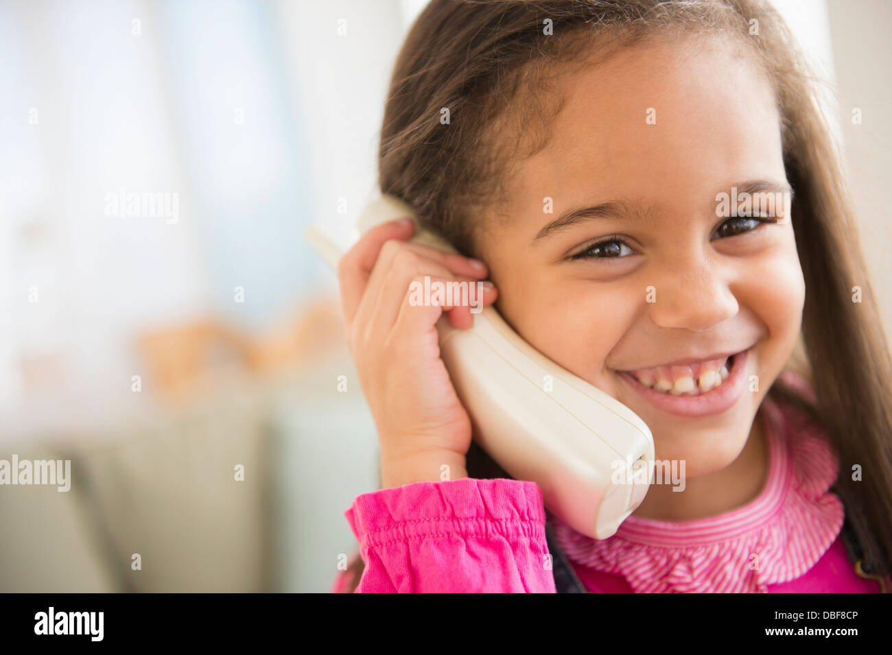 Hispanic girl talking on telephone Stock Photo - Alamy