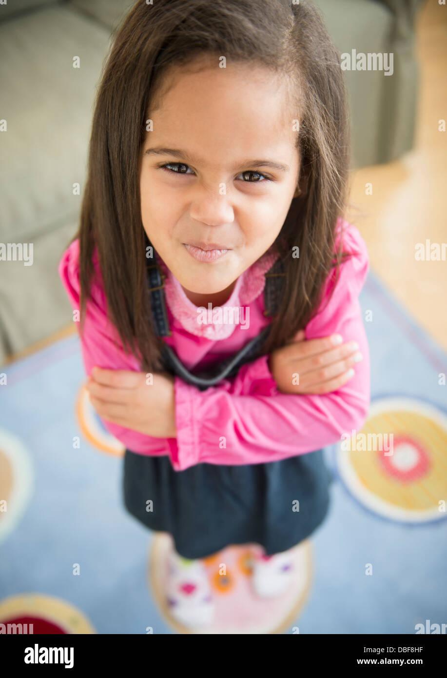 Hispanic girl pouting in living room Stock Photo - Alamy