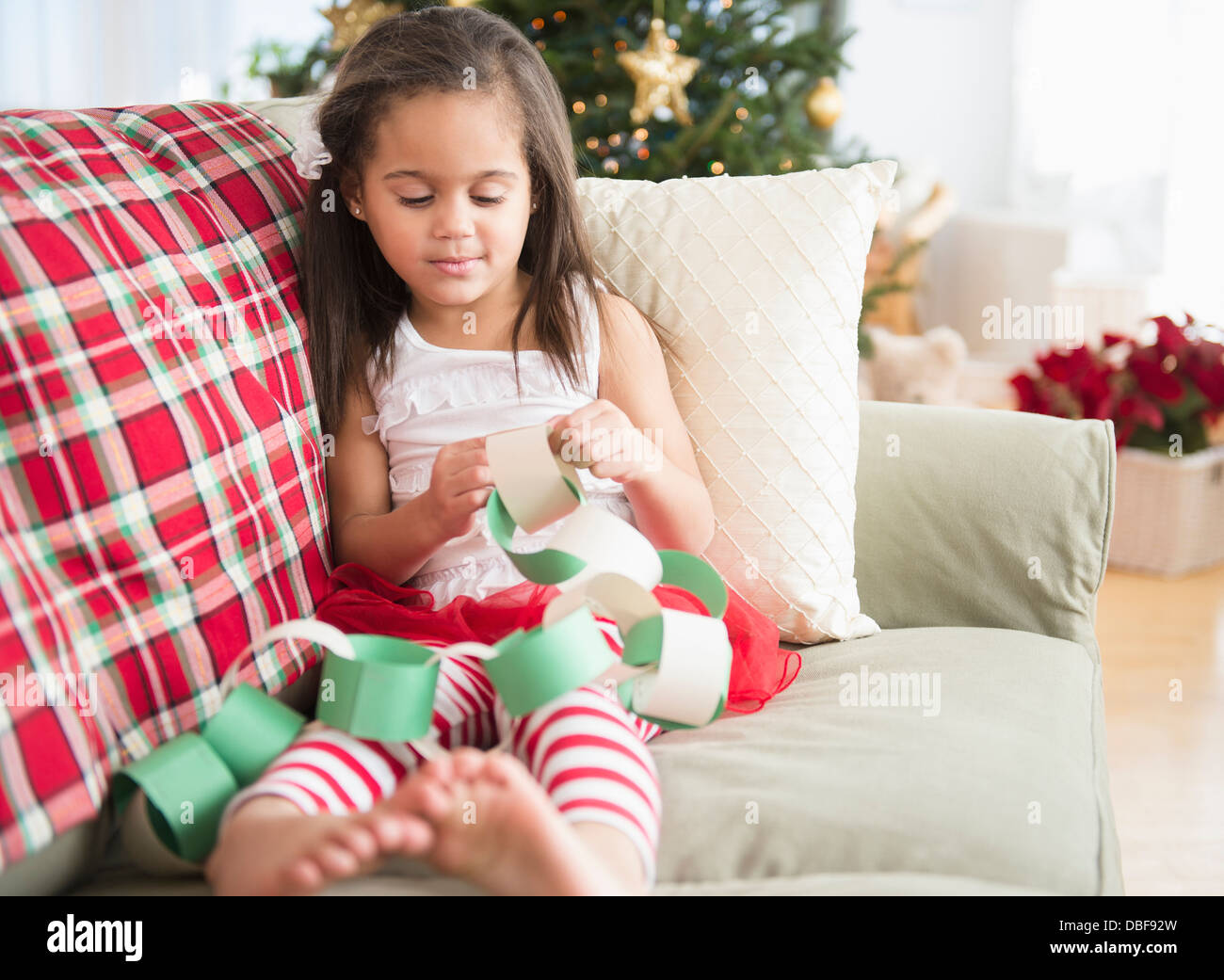 Child holding paper chain decoration hi-res stock photography and ...