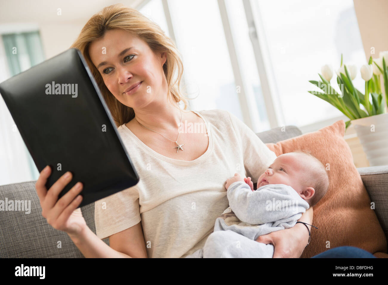 Caucasian mother with baby using tablet computer Stock Photo - Alamy