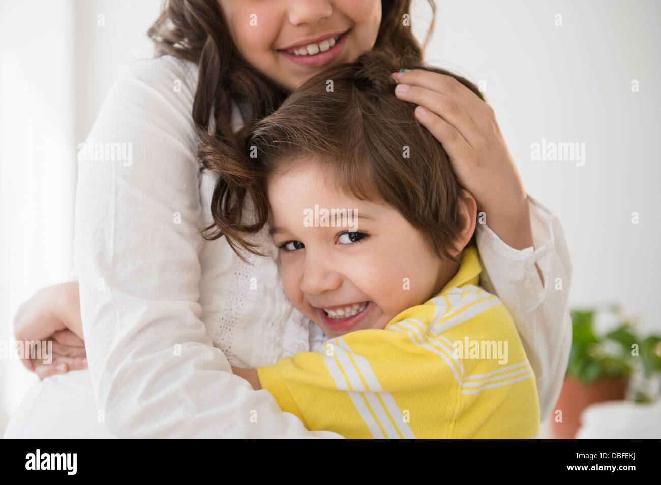 Hispanic children hugging Stock Photo - Alamy