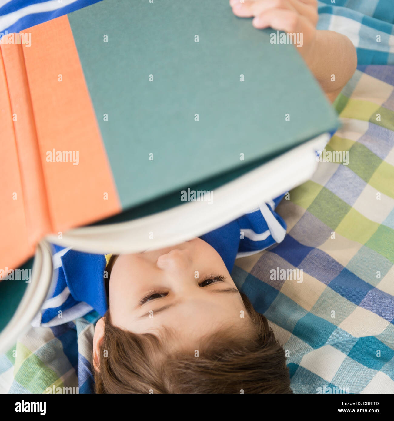 Hispanic boy reading on bed Stock Photo - Alamy