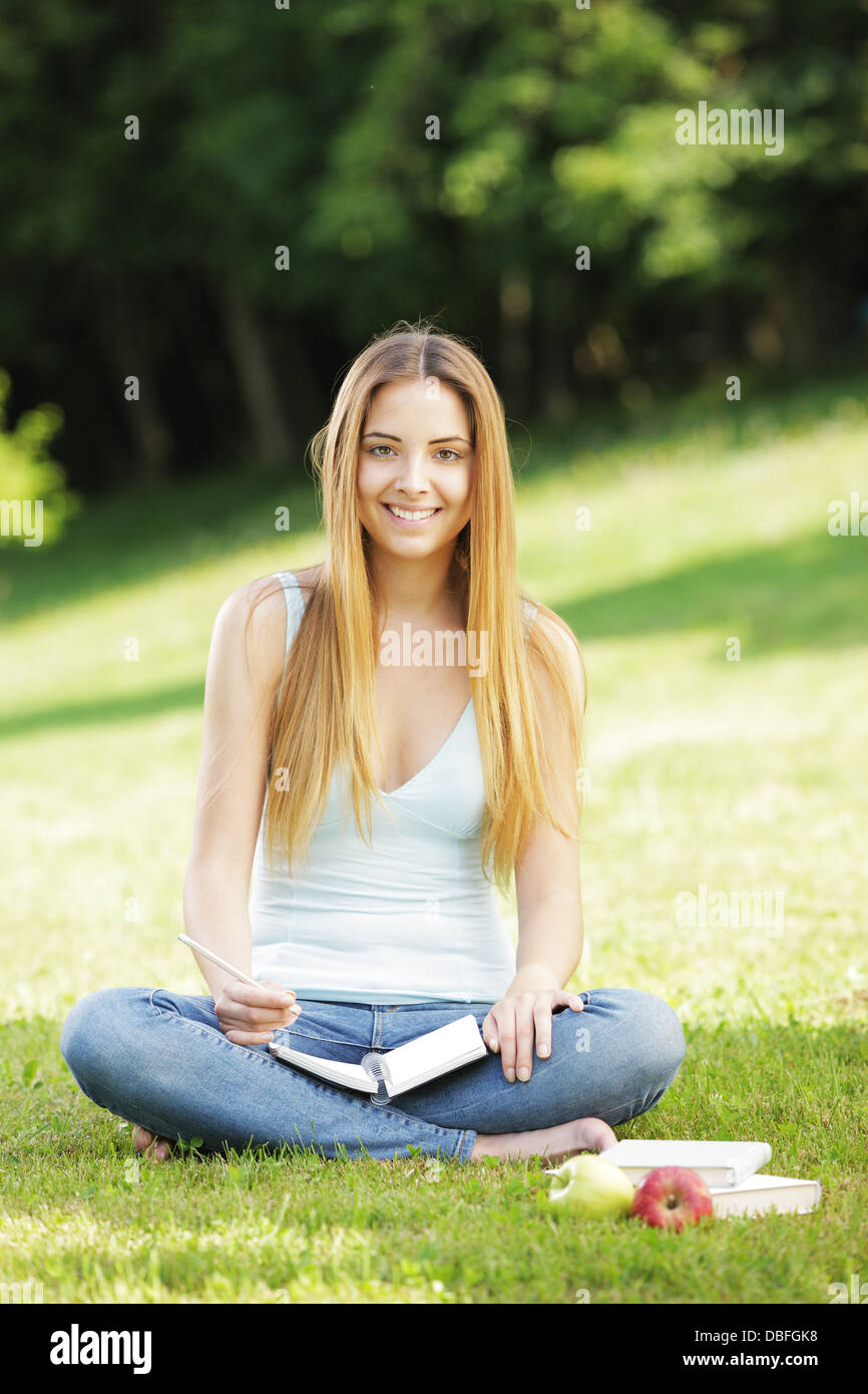 Smiling woman taking a break Stock Photo - Alamy