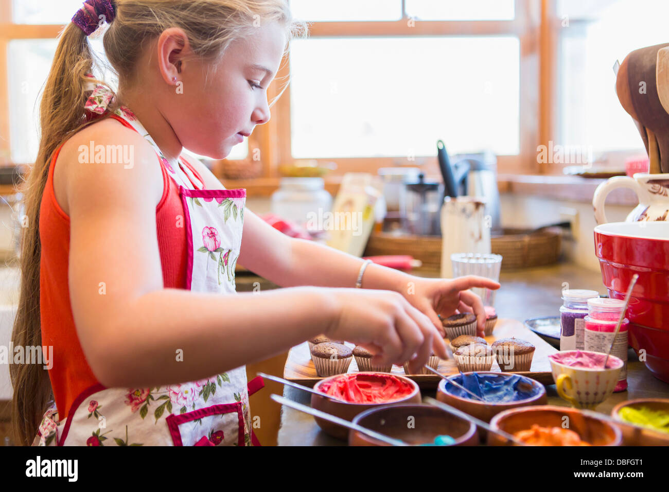 Caucasian girl making cupcakes Stock Photo - Alamy