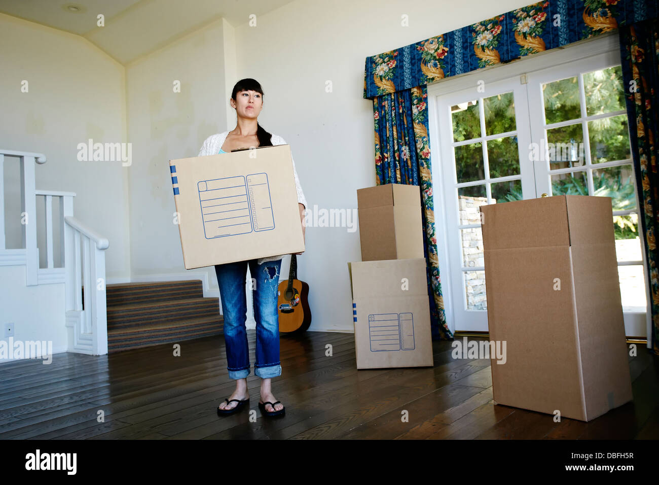 Young person carrying moving box hi-res stock photography and images ...