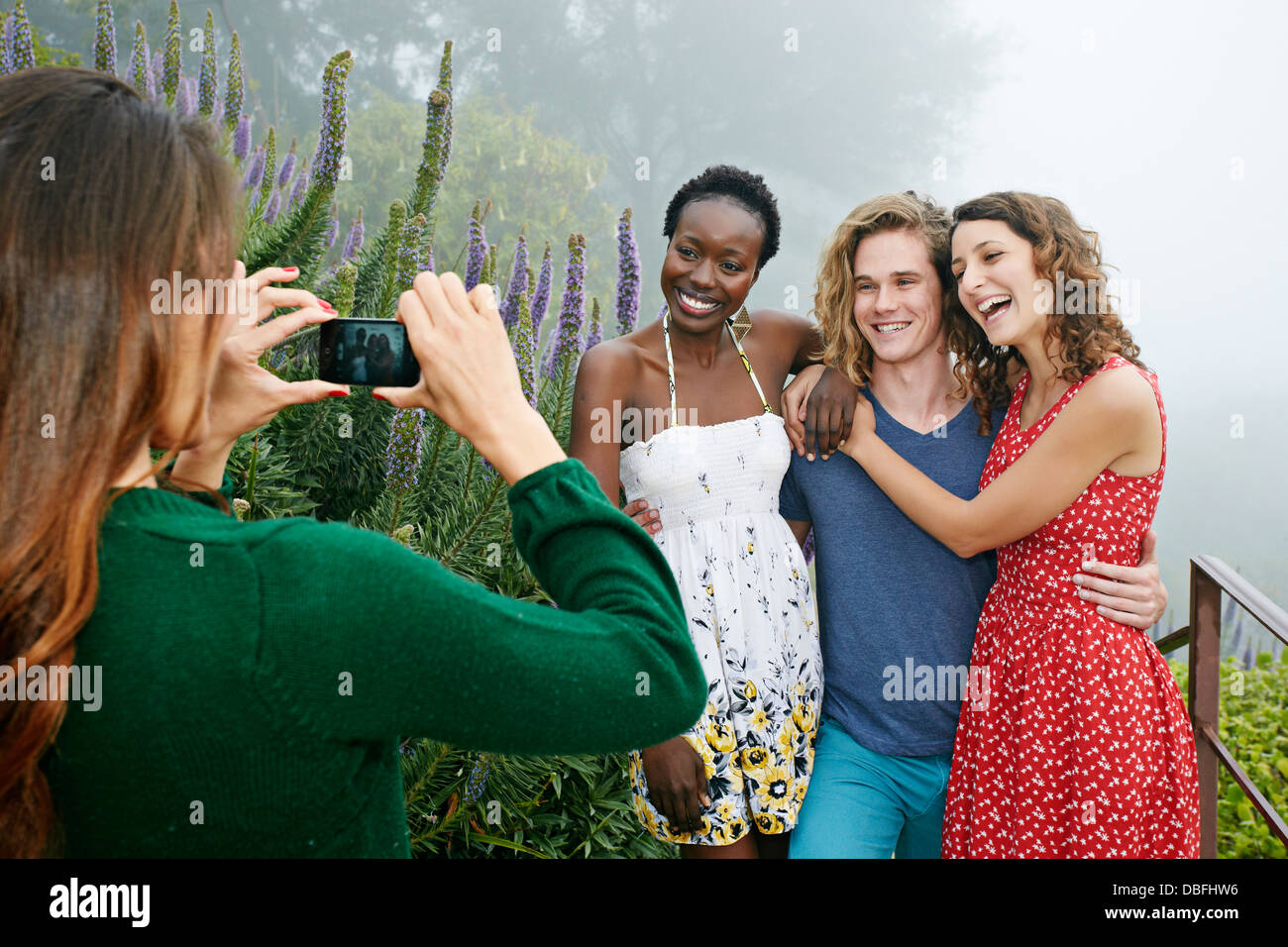 Friends taking pictures together outdoors Stock Photo - Alamy