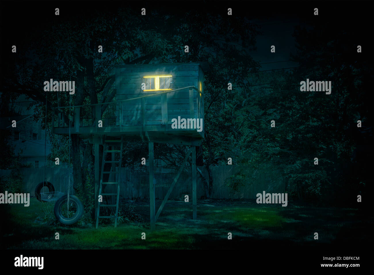 Illuminated treehouse in backyard at night Stock Photo - Alamy