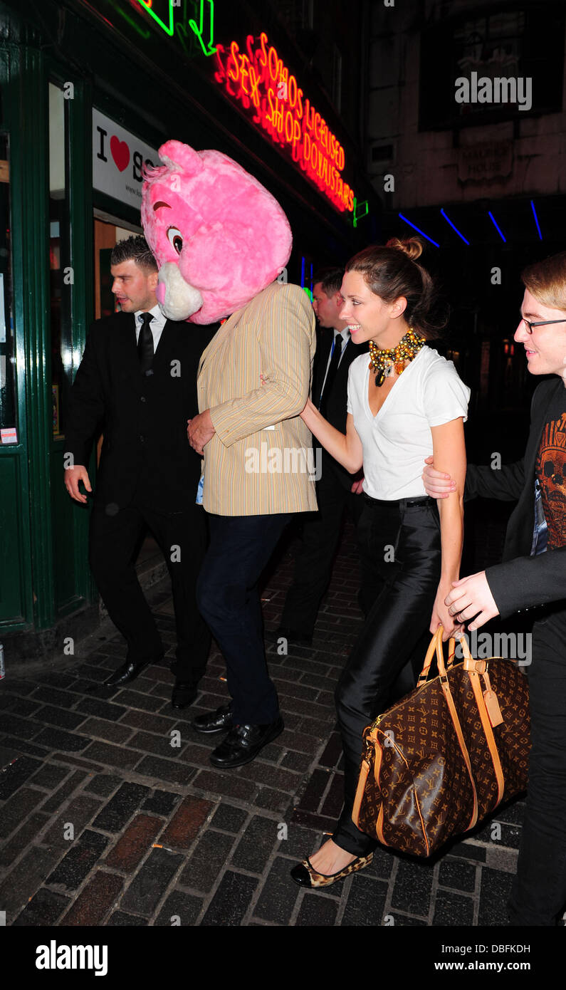 Stephen Fry wearing an oversized pink Care-Bear head and Margo Stilly ...
